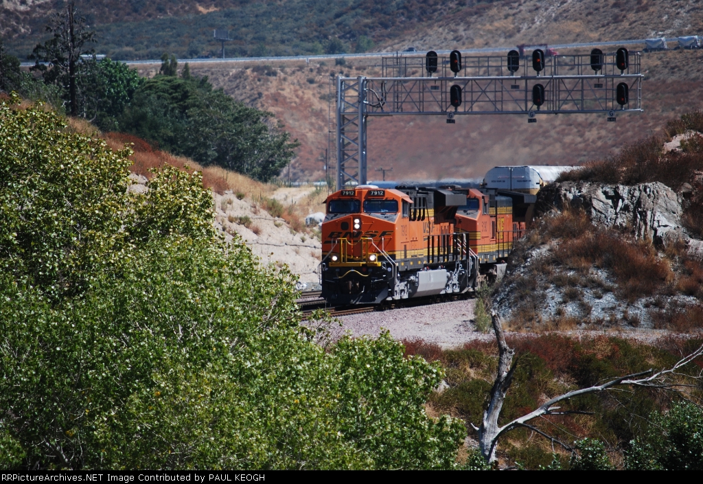 BNSF 7912 and the rest of her vehicle train come into full view as she heads south/west.